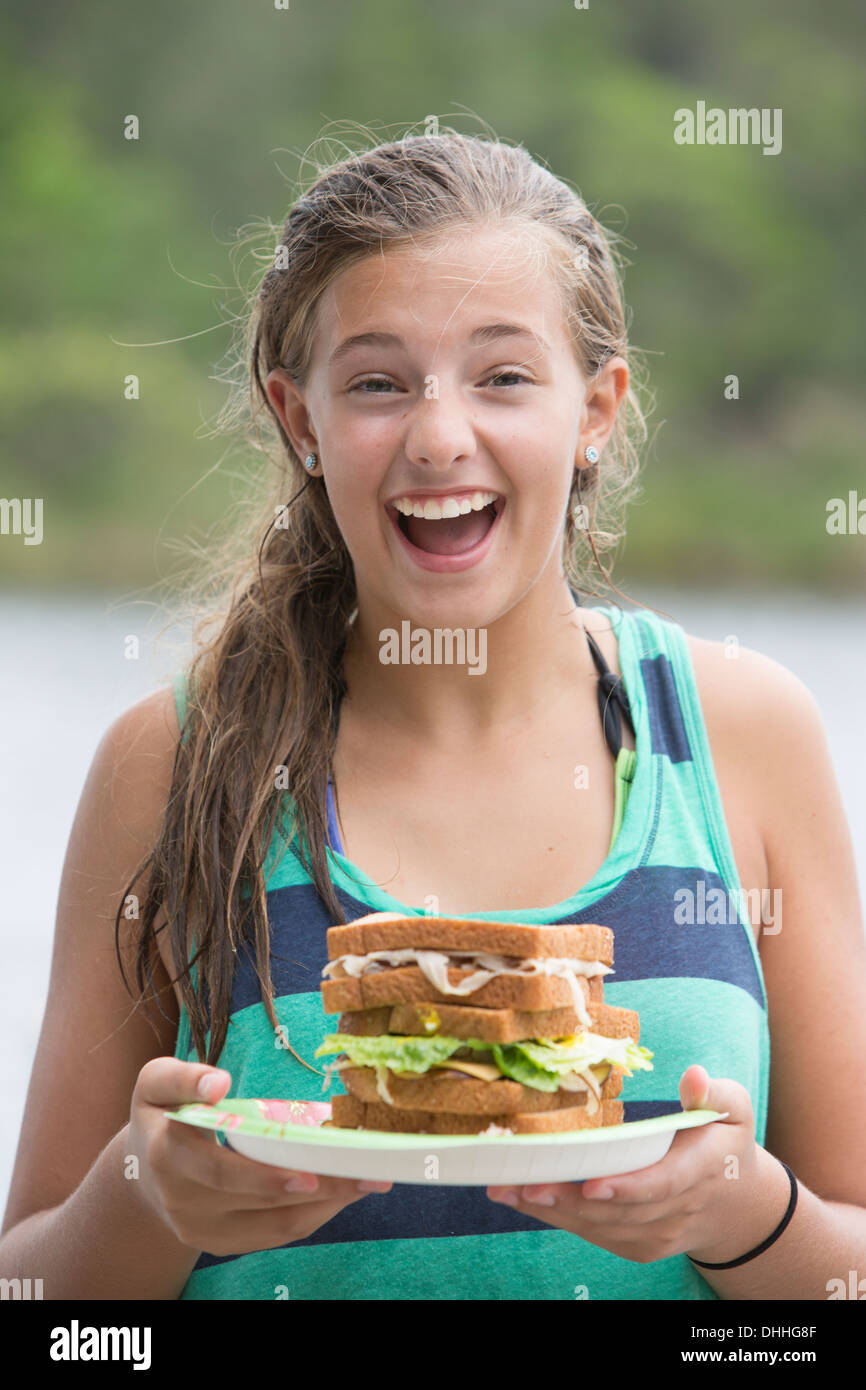 Portrait of teenage girl holding sandwich Stock Photo - Alamy