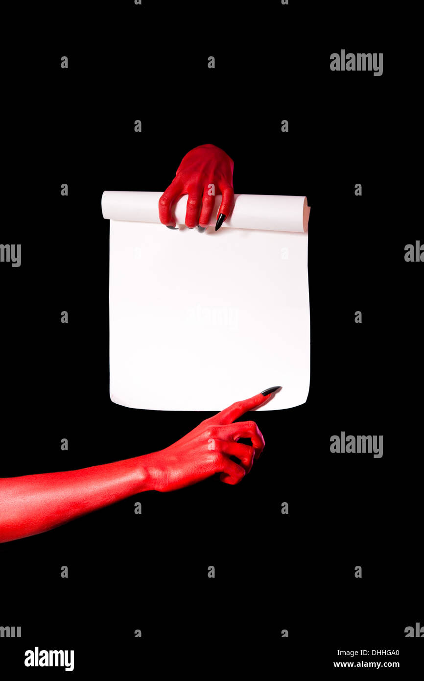 Red devil hands holding paper scroll and pointing at signature place ...