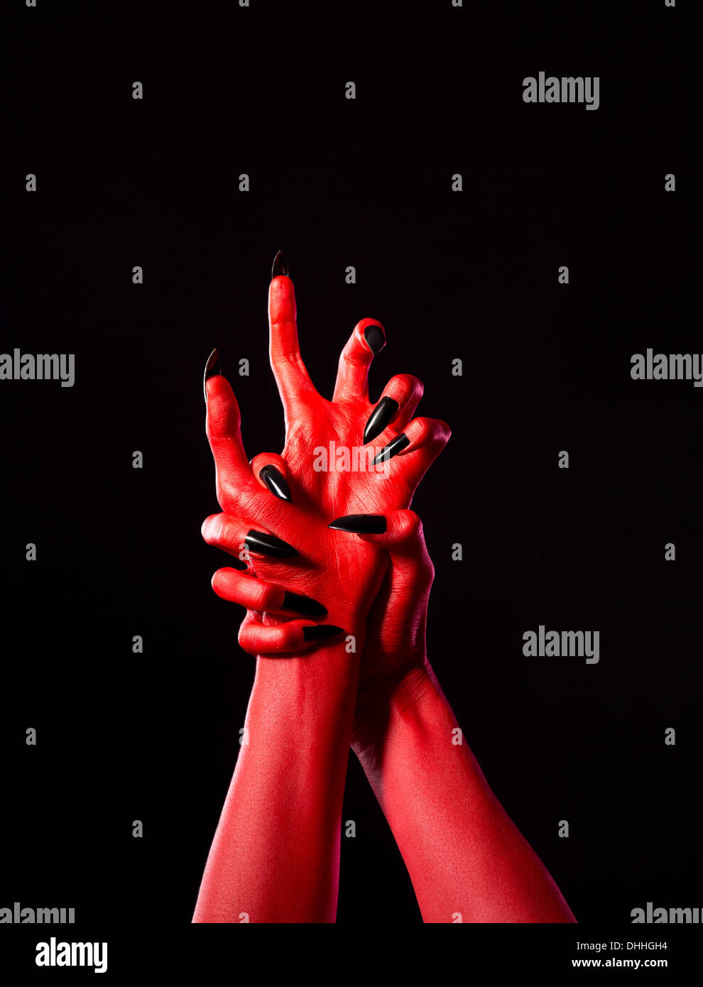 Red demonic hands with black nails, Halloween theme, isolated on black ...
