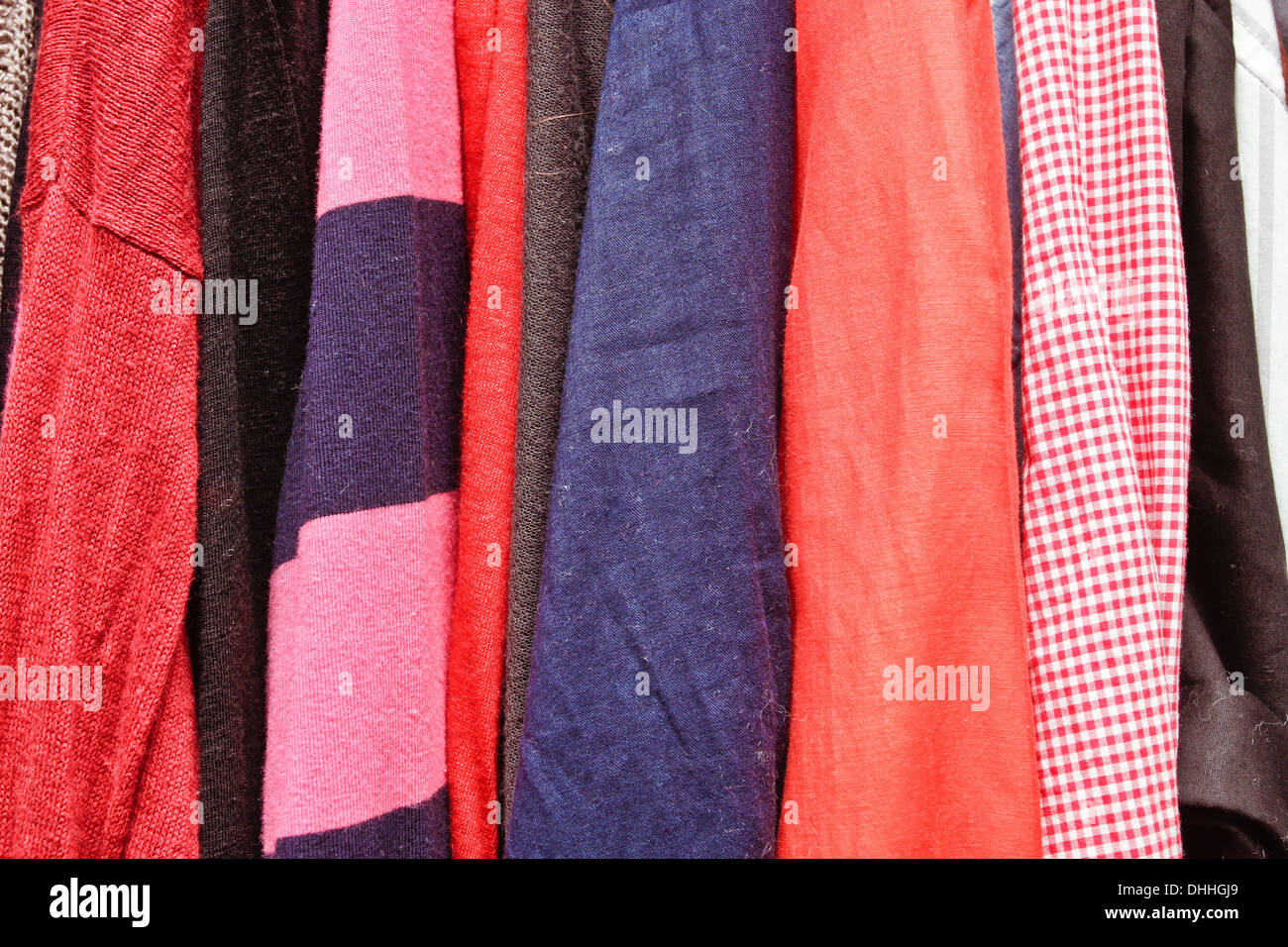 Selection of colorful hanging tops as a background Stock Photo - Alamy