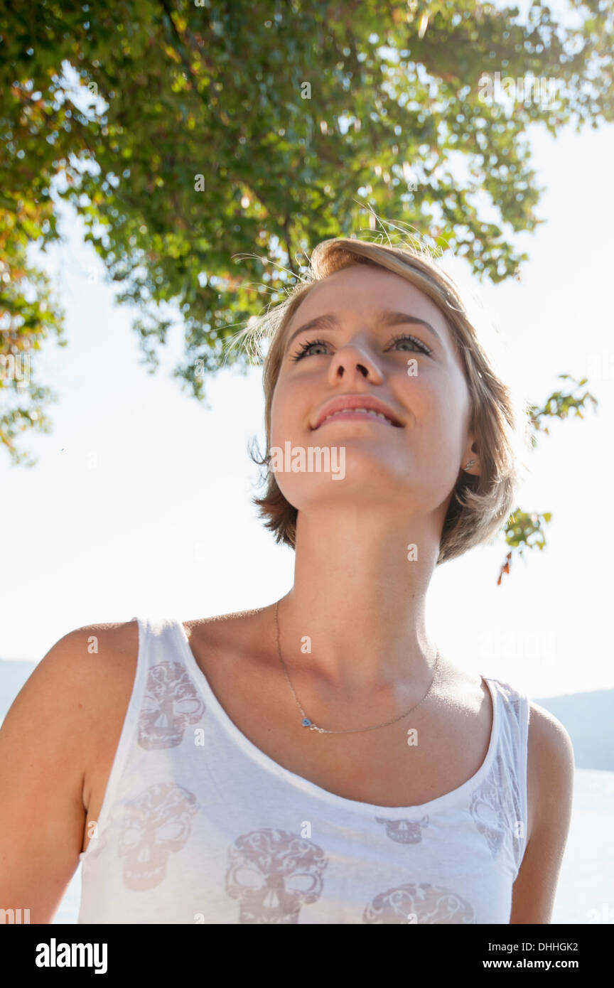 Portrait of young woman looking away Stock Photo - Alamy