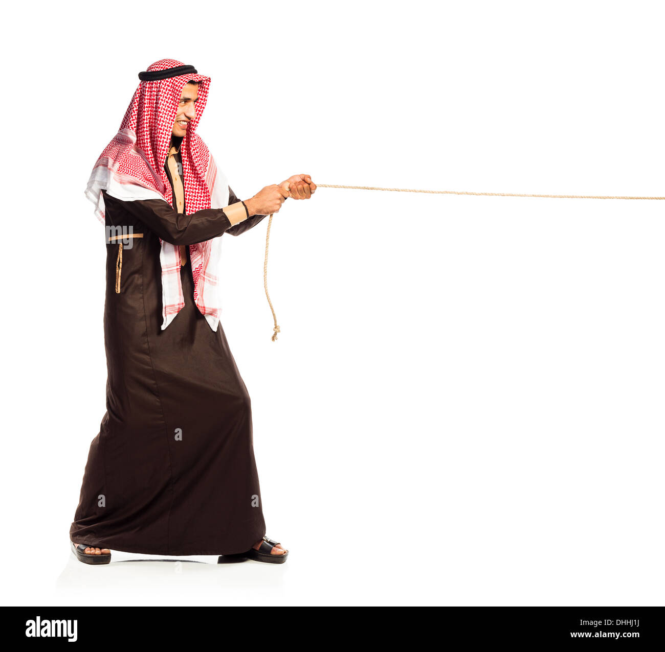 Young Arab pulling a rope isolated on white background Stock Photo - Alamy