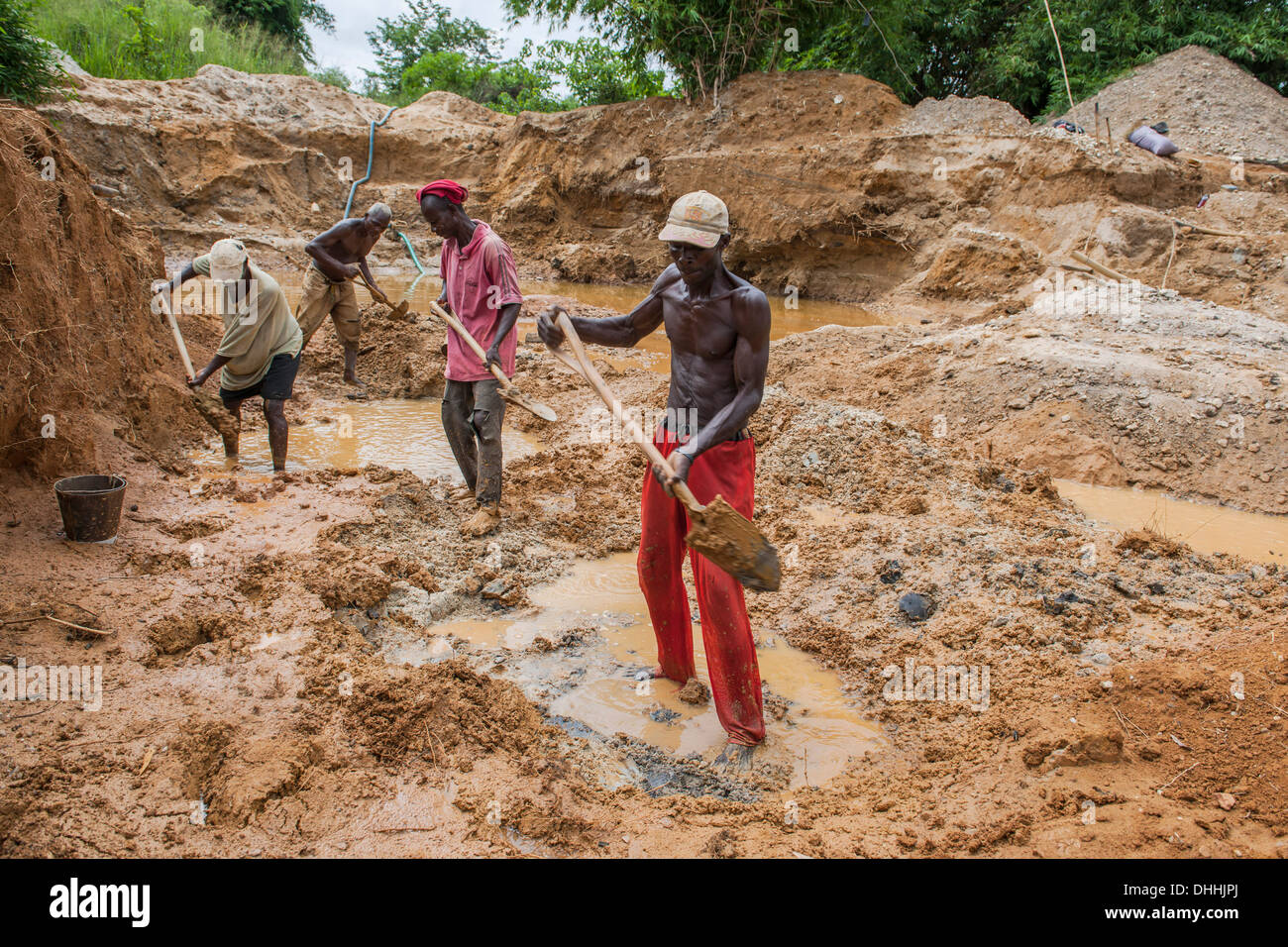Workers digging at a diamond mine in the jungle, Kenema, Eastern ...