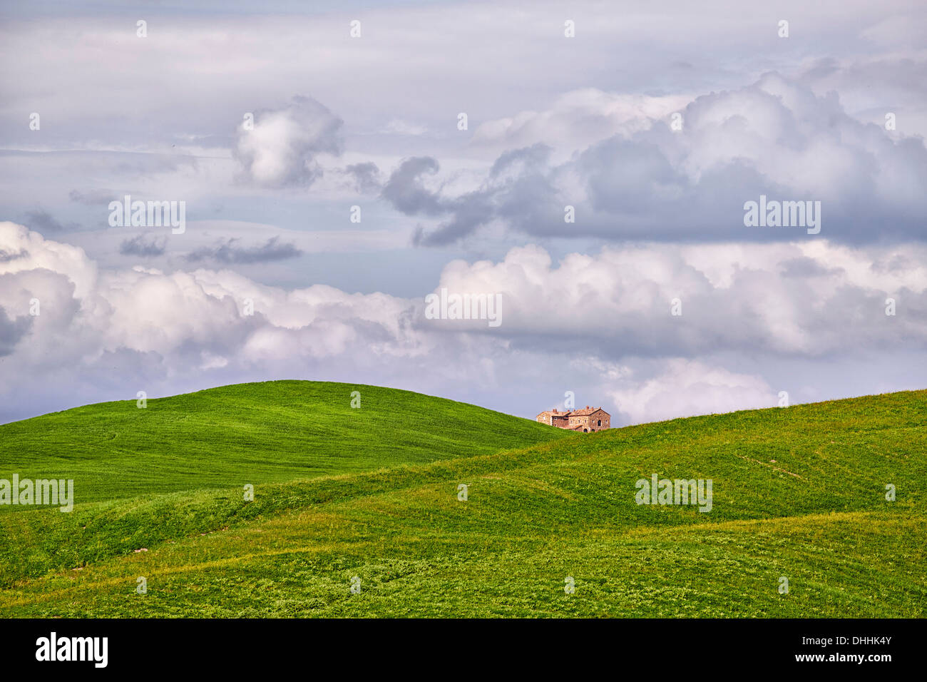 Single house between clouds and hilly fields, Torrenieri, Montalcino ...