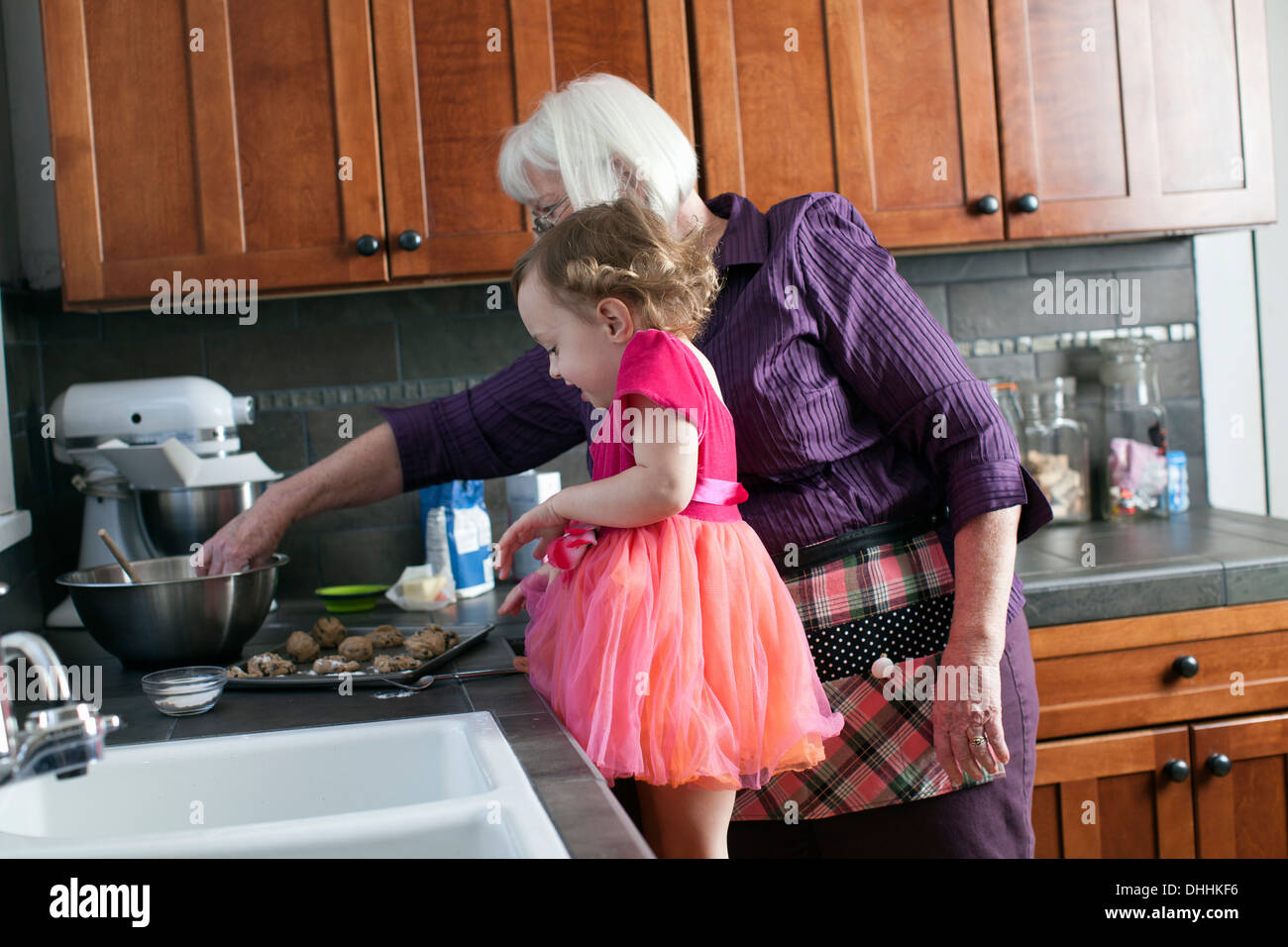 Old woman baking cookies hi-res stock photography and images - Alamy