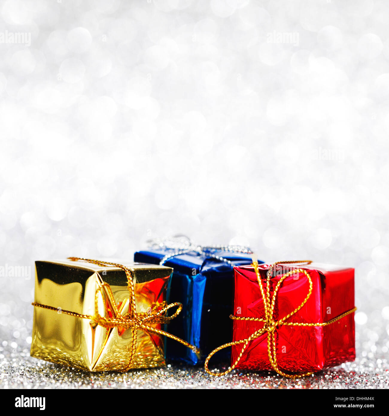 Gift boxes on glitter silver background Stock Photo - Alamy