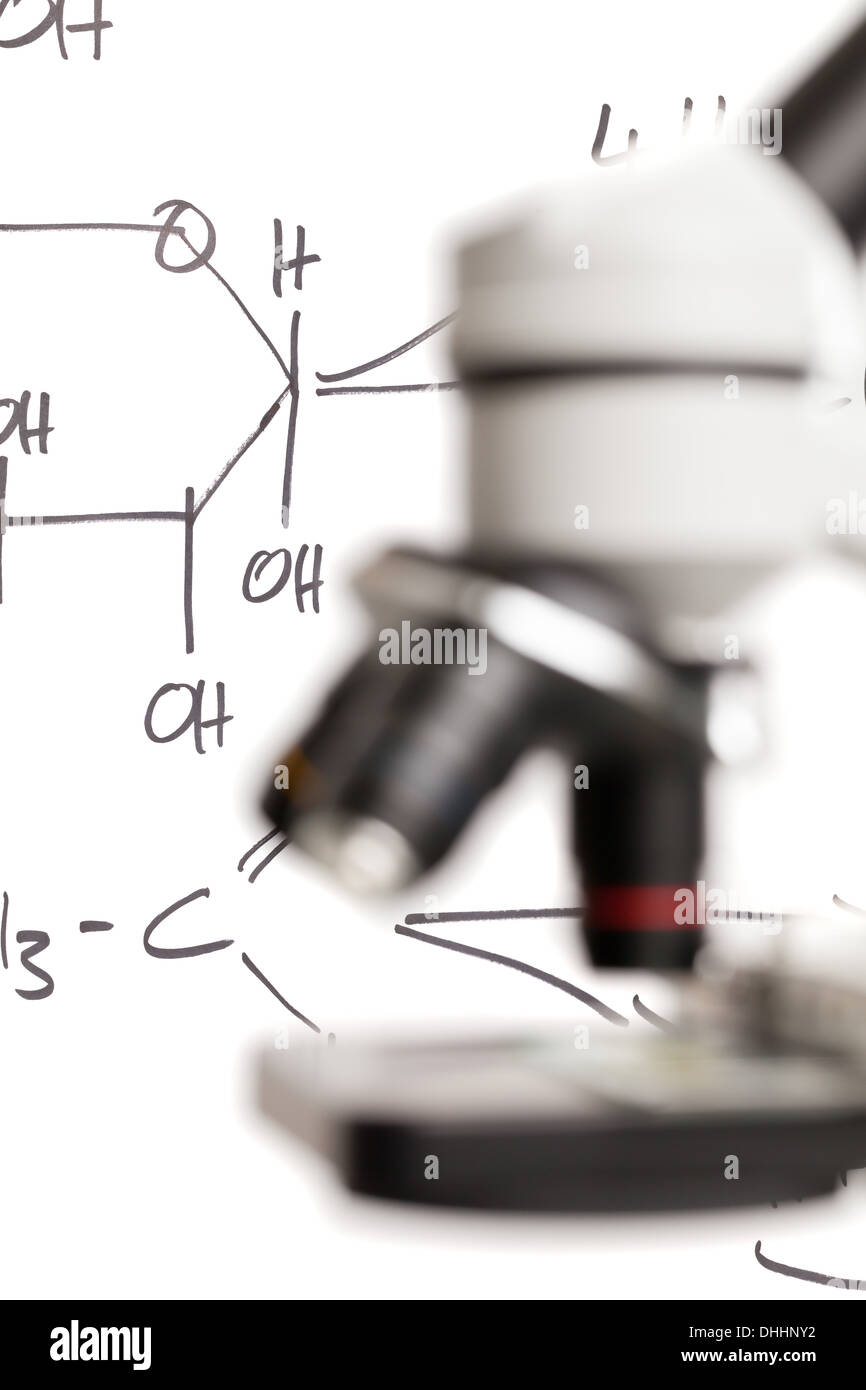 Microscope in front of whiteboard with chemical formula Stock Photo - Alamy