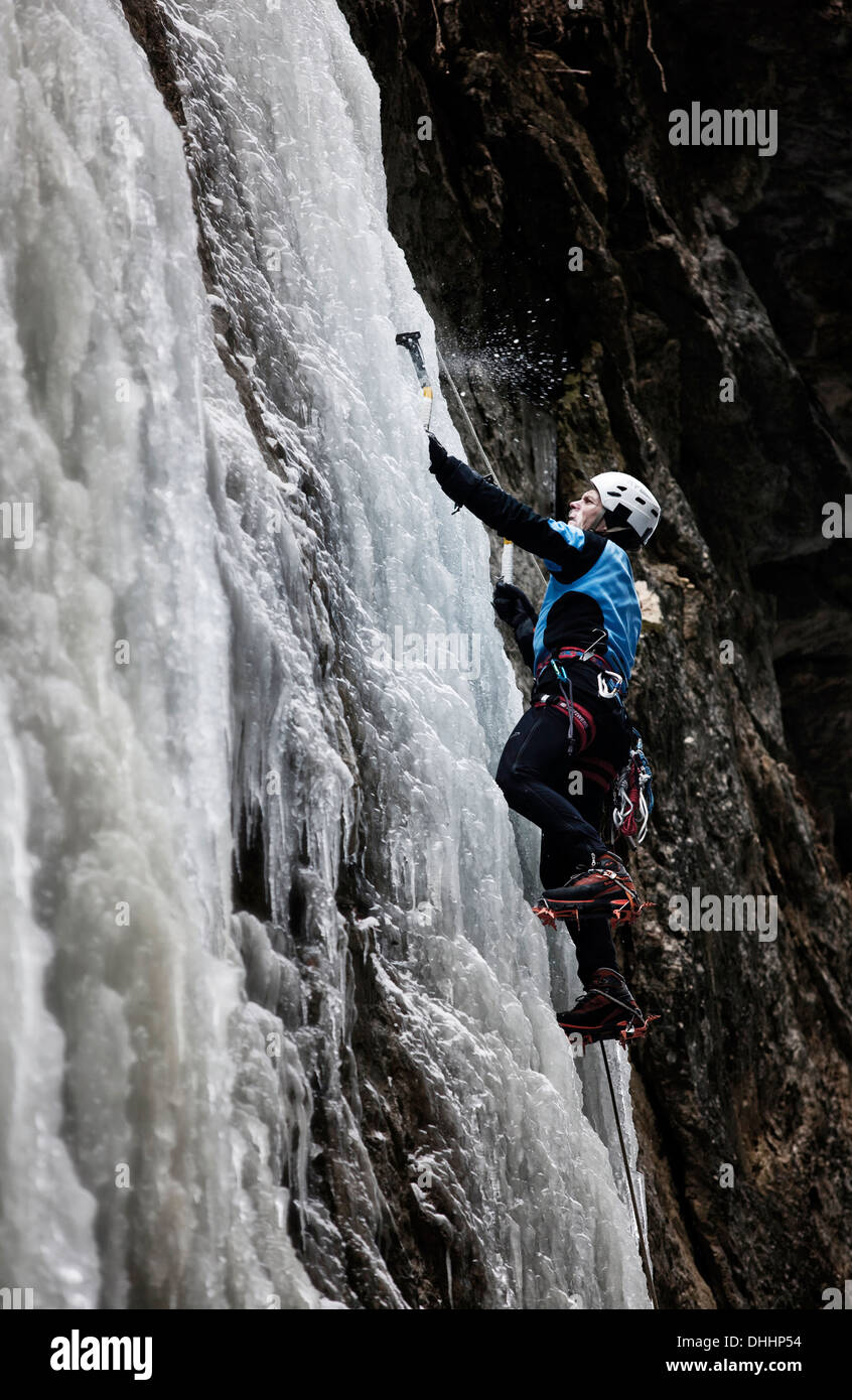 Ice climber climbing a frozen waterfall, Alpbach, Alpbachtal valley ...