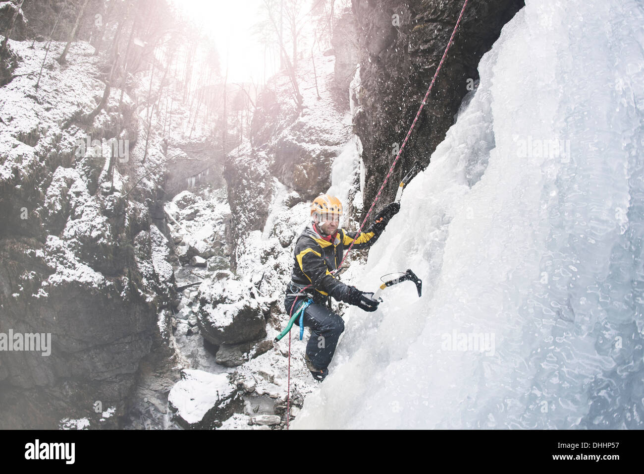 Ice climber climbing a frozen waterfall, Alpbach, Alpbachtal valley ...