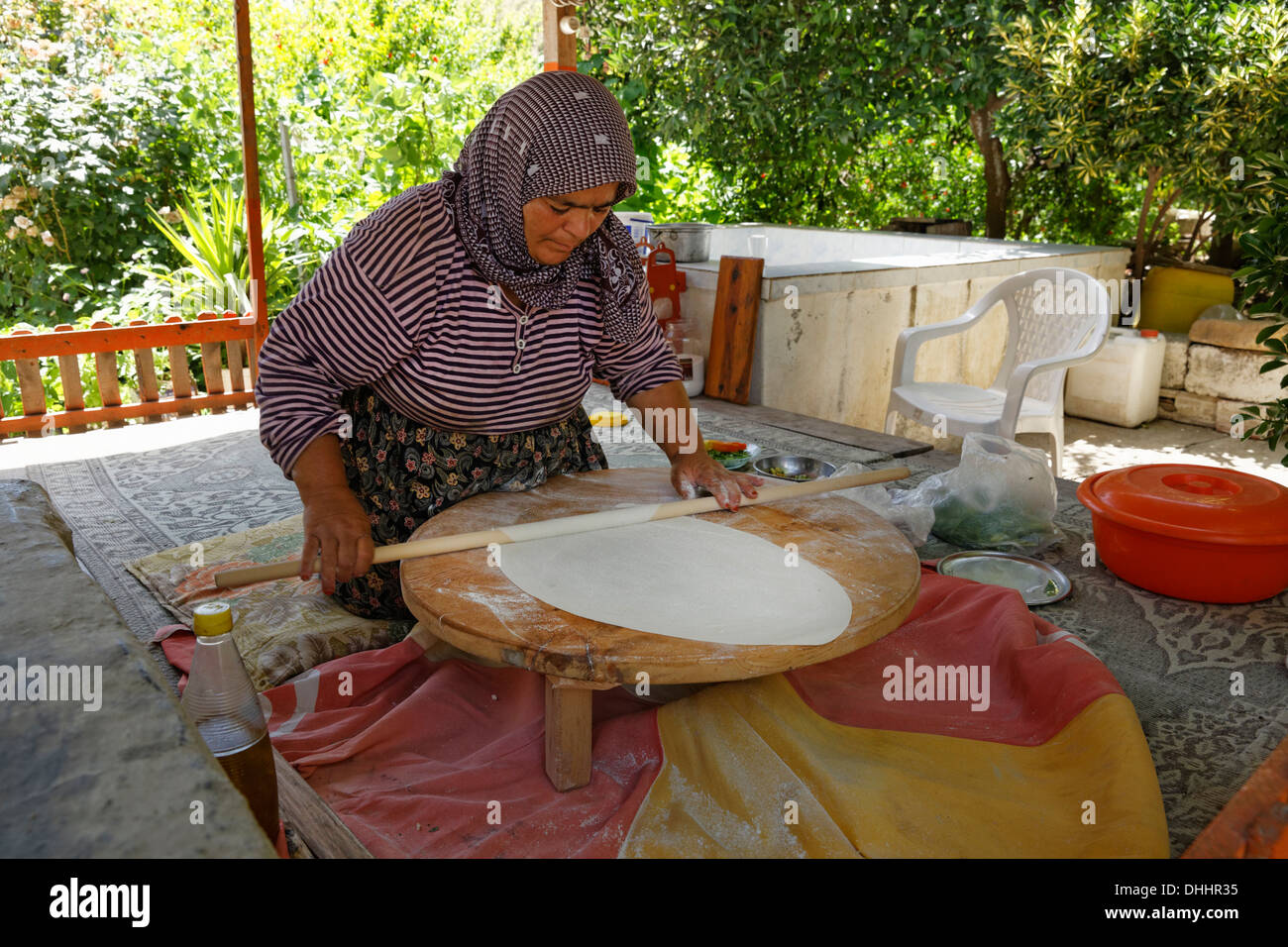 Woman rolling dough for Goezleme flatbread, Anatolian cuisine, Antalya ...