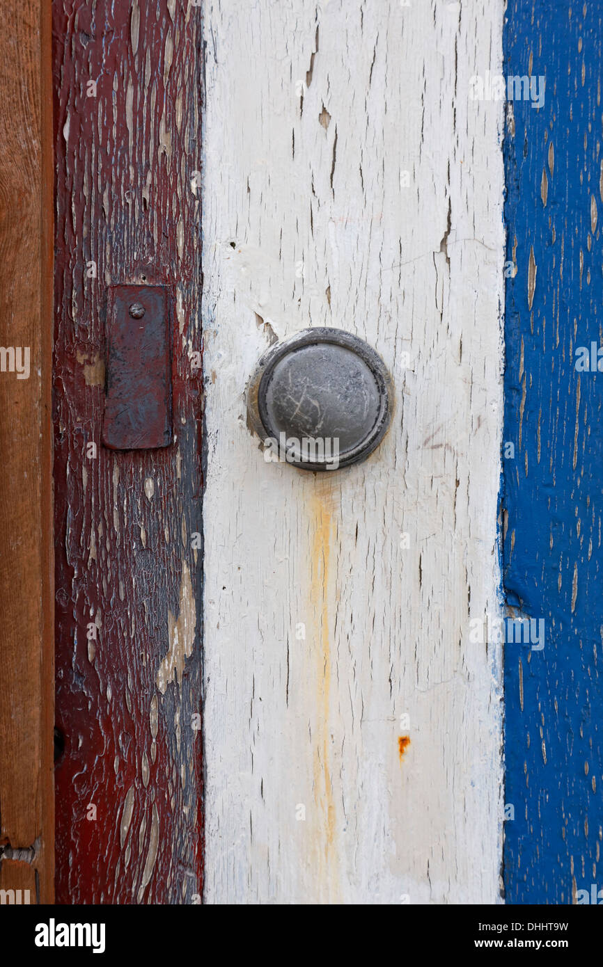 Peeling red, white and blue paint on a run down beach hut door Stock ...