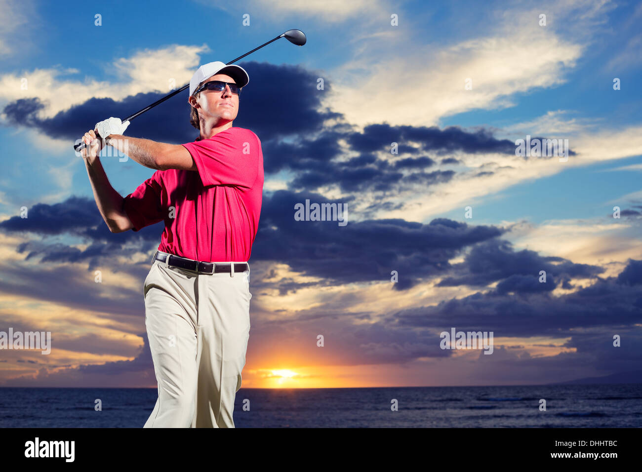 Golfer at sunset, Man swinging golf club with dramatic sunset sky ...
