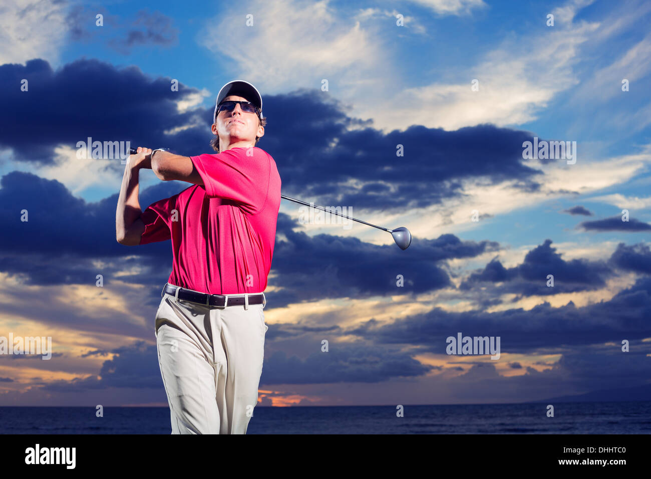 Golfer at sunset, Man swinging golf club with dramatic sunset sky ...