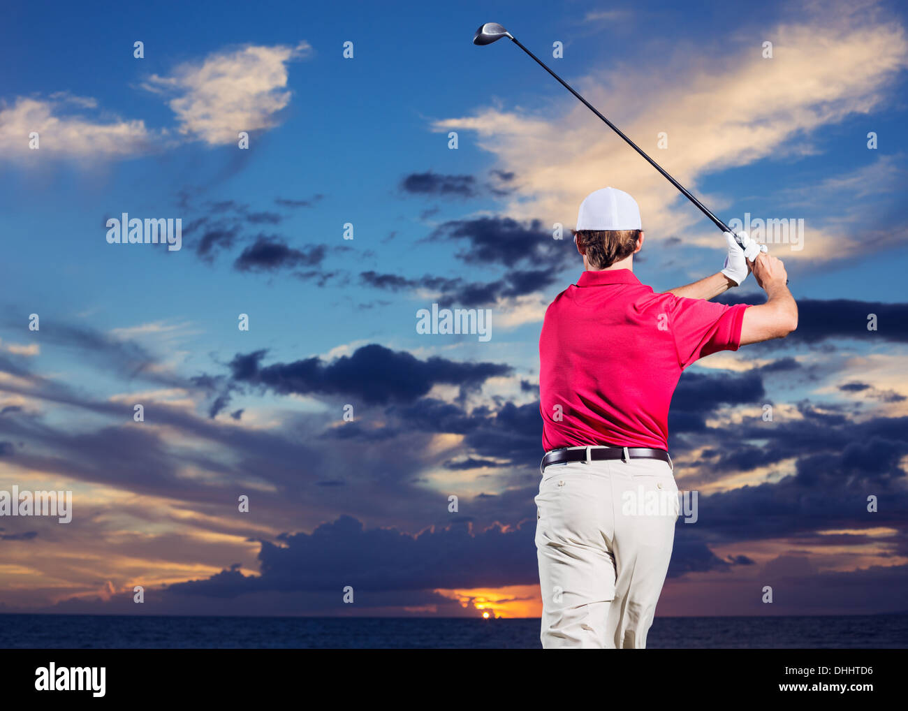 Golfer at sunset, Man swinging golf club with dramatic sunset sky ...