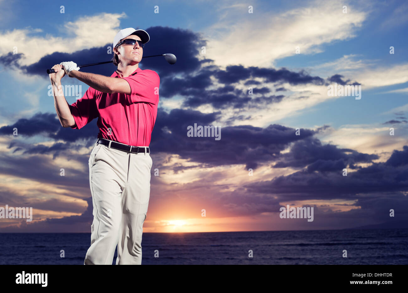 Golfer at sunset, Man swinging golf club with dramatic sunset sky ...