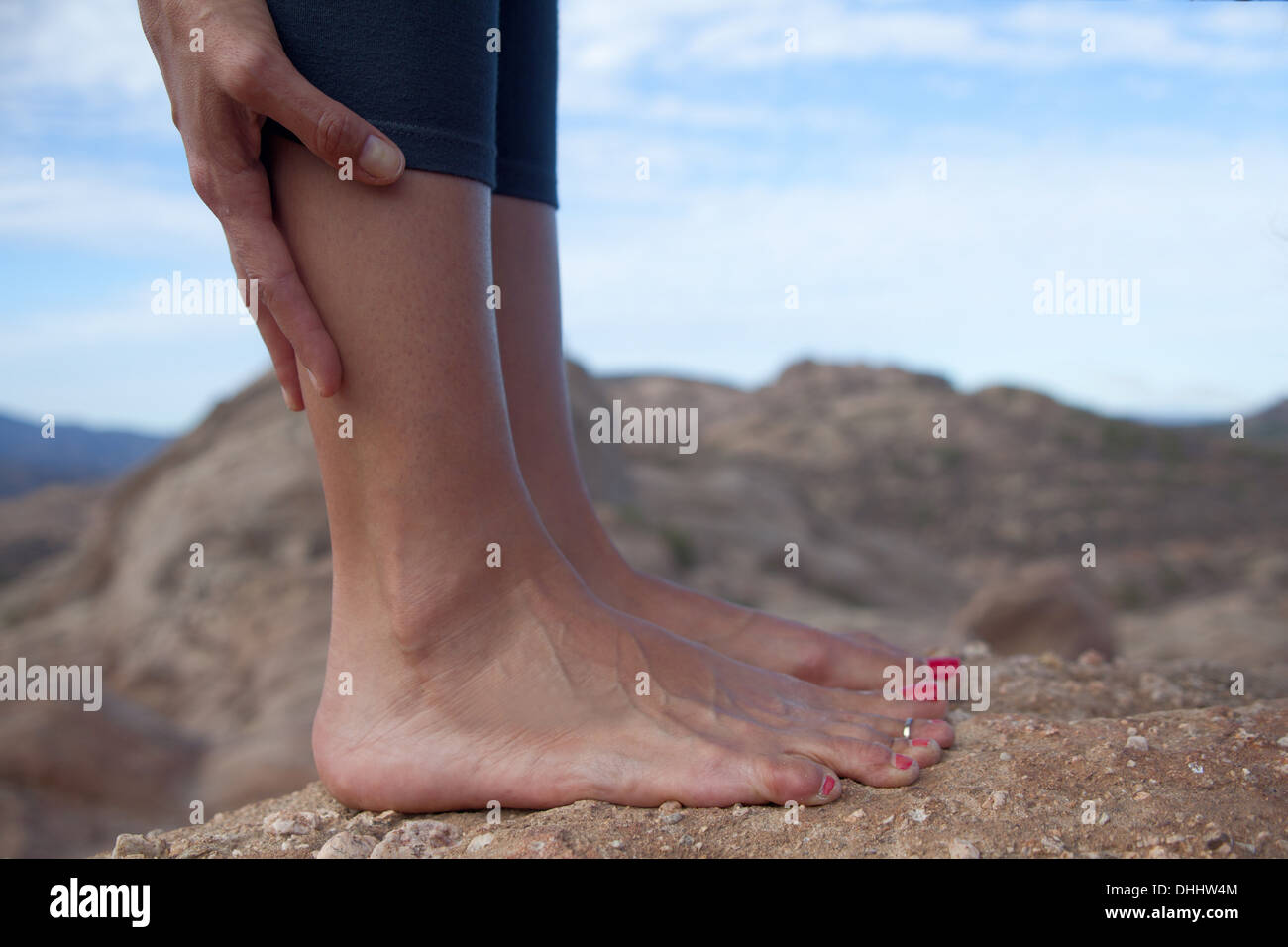 Cropped image of woman's bare feet standing on rocks Stock Photo - Alamy
