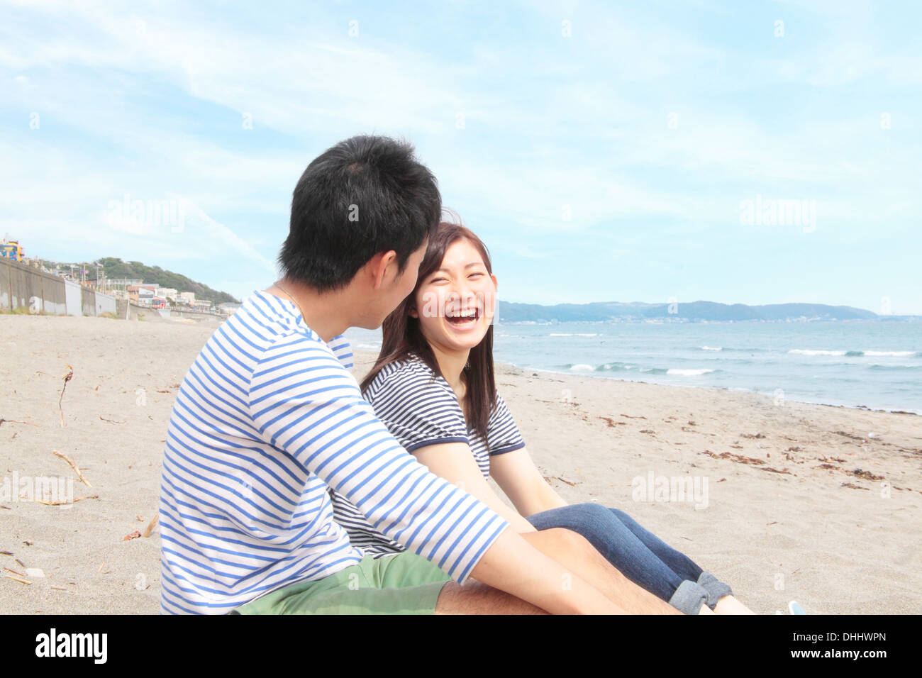 Two People Sitting On The Beach High Resolution Stock Photography and ...
