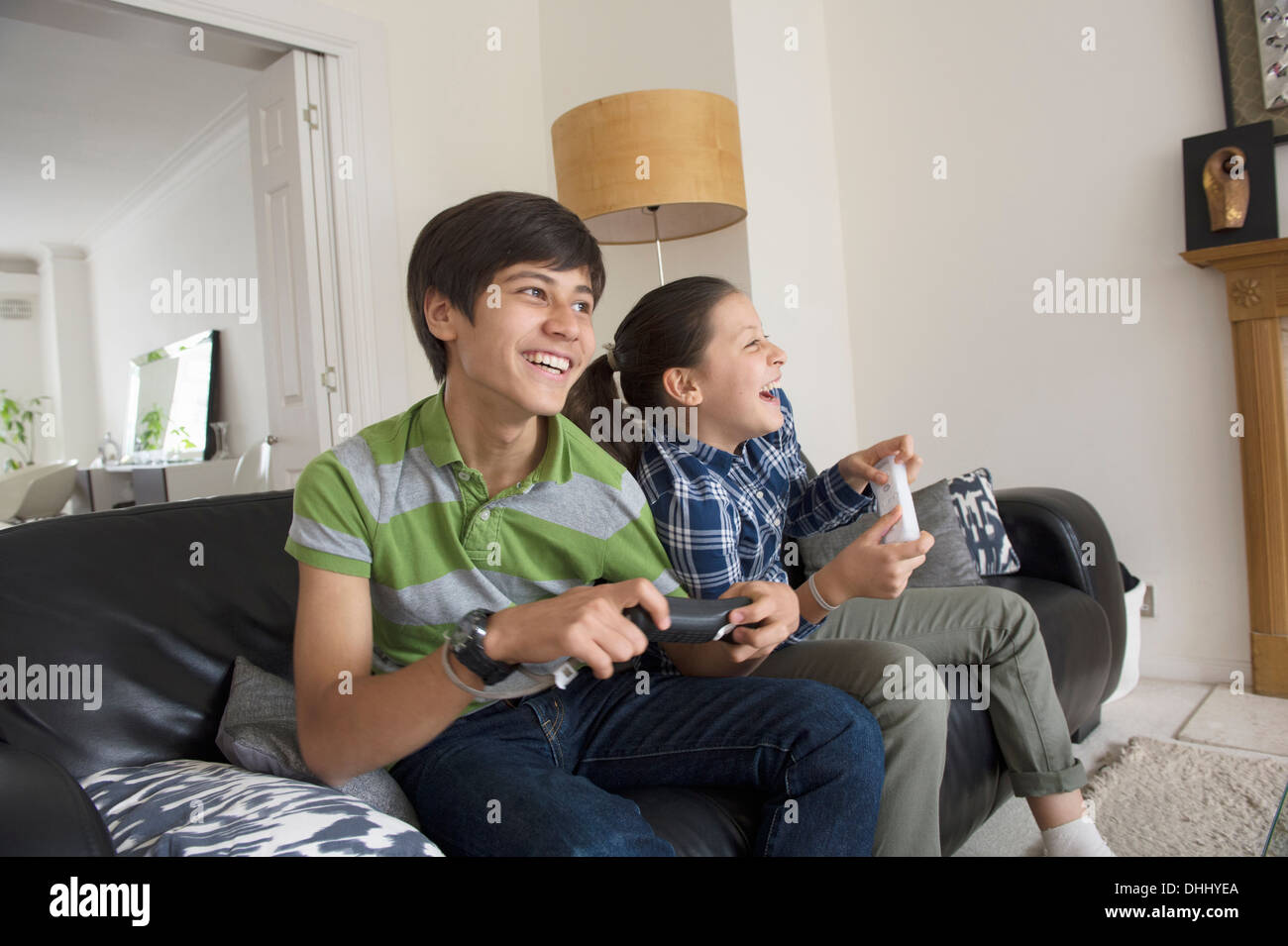 Brother and sister playing video game Stock Photo - Alamy
