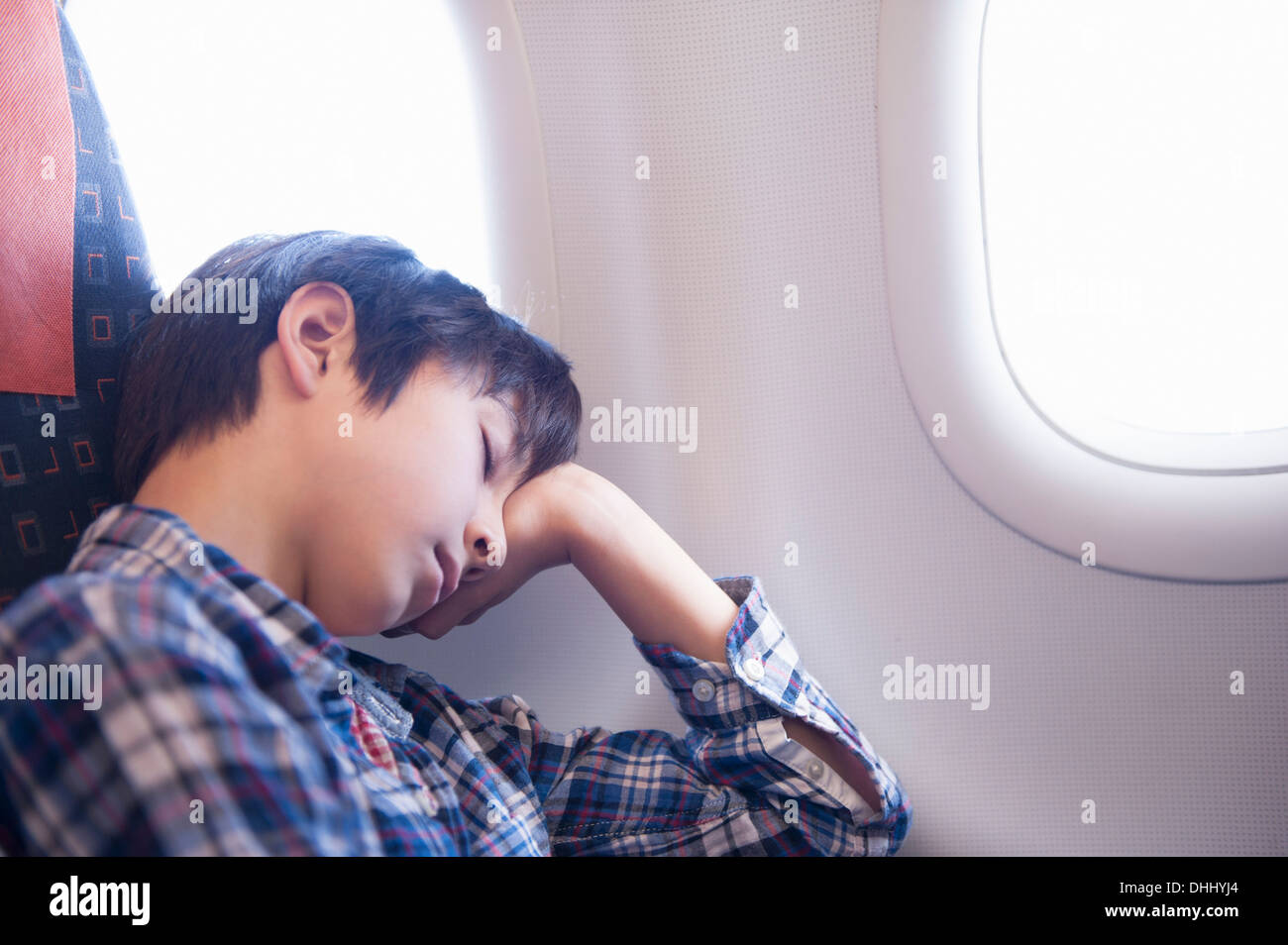 Boy asleep on aeroplane Stock Photo - Alamy