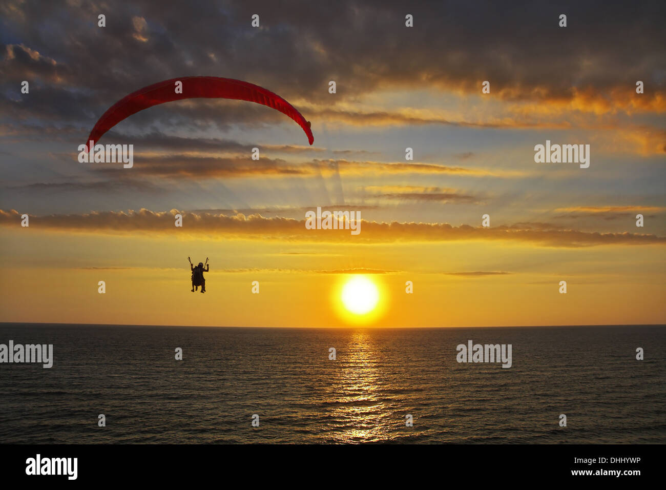 The parachute above the sea on a sunset Stock Photo - Alamy