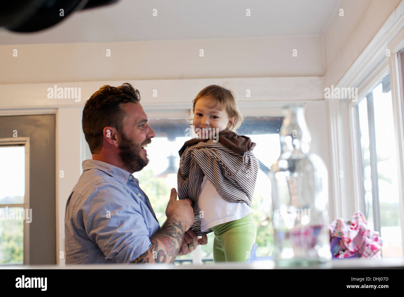 Father getting daughter dressed Stock Photo - Alamy
