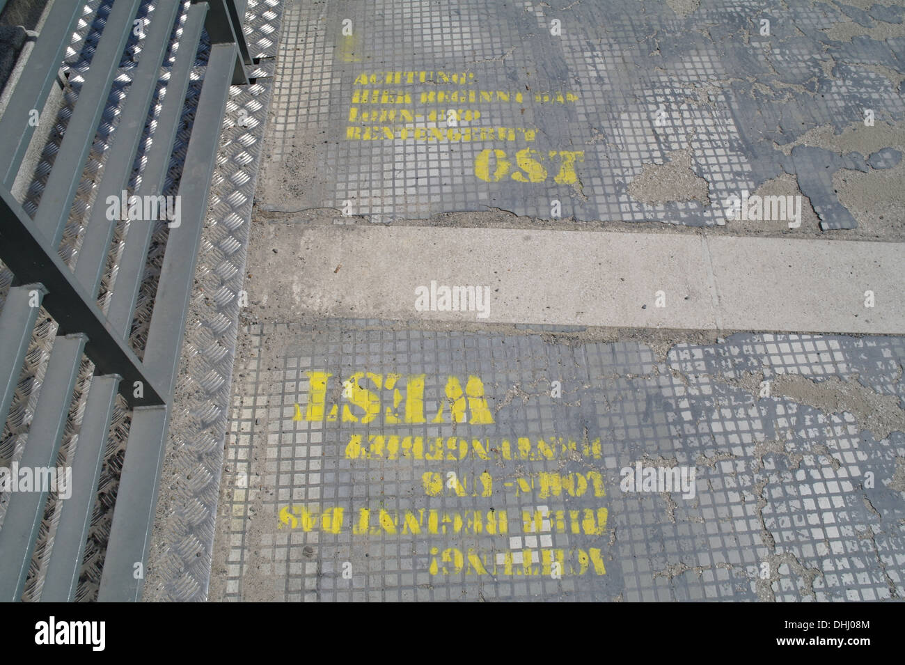 Yellow 'Ost' 'West' lettering either side of the Cold War East West ...