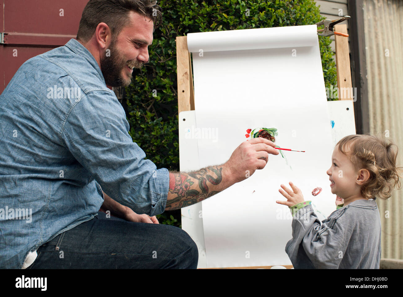 Father fooling around painting on daughter's face Stock Photo - Alamy