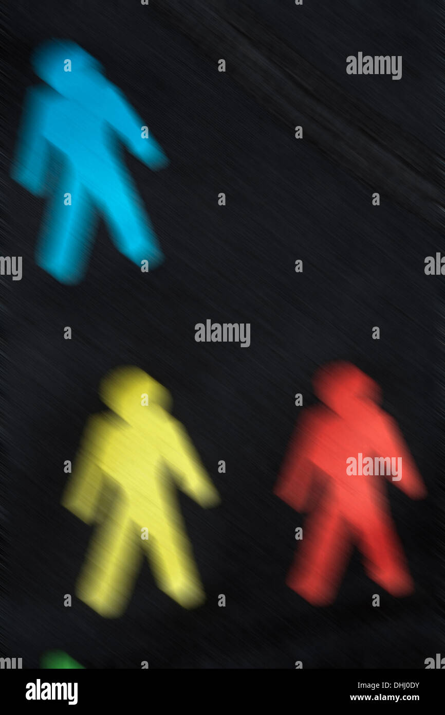 concept of moving men - red yellow and blue male symbols on pair of ...