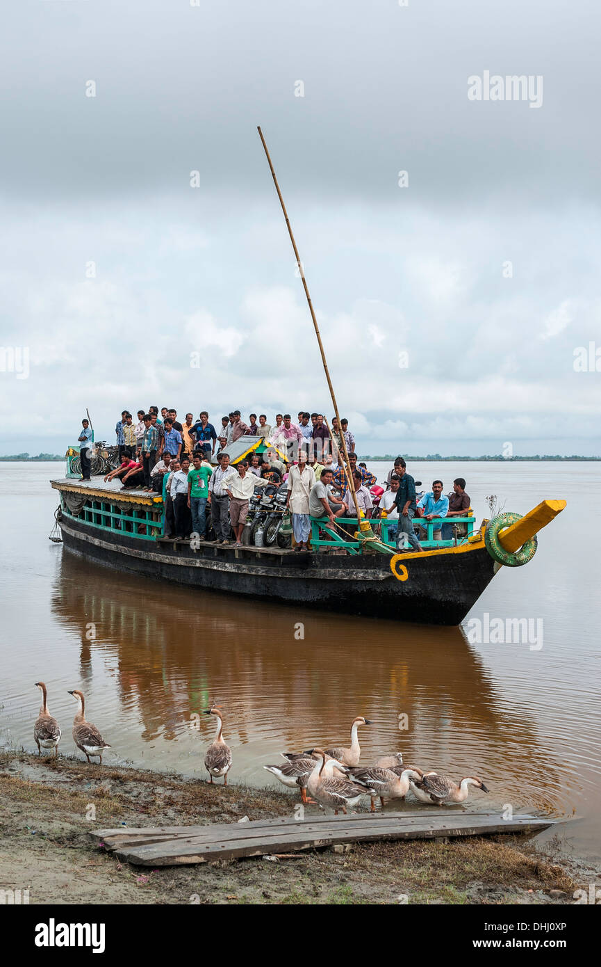 Overcrowded passenger ferry arrives at Nimati Ghat from Majuli island ...