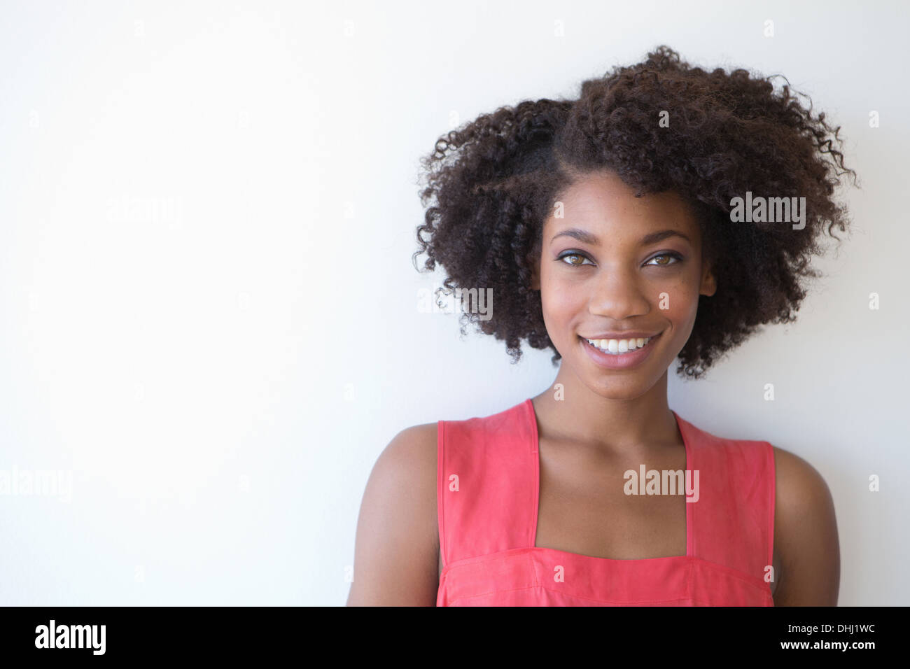 Portrait of young woman against white background Stock Photo - Alamy