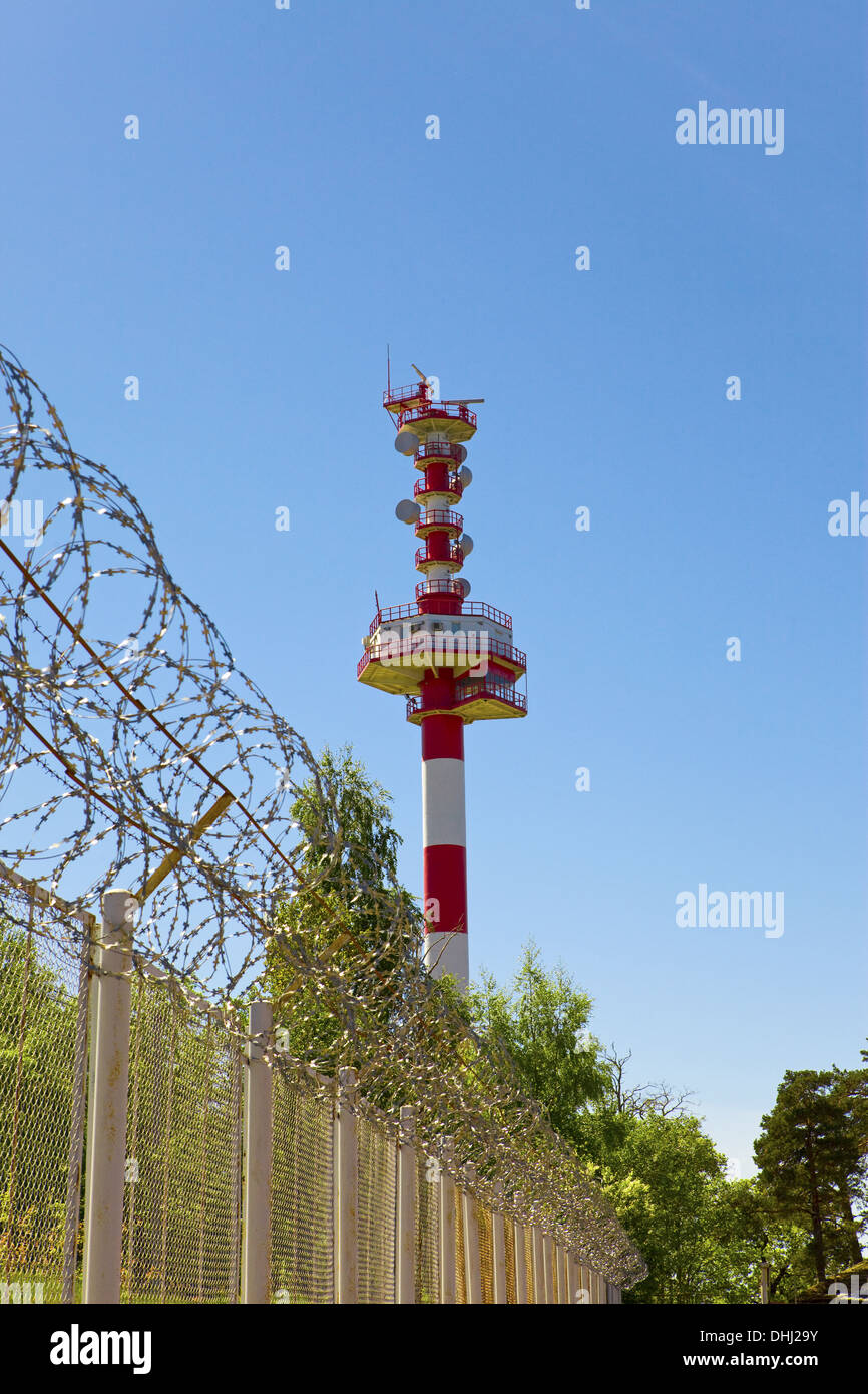 Lighthouse behind fence from barbed wire Stock Photo - Alamy