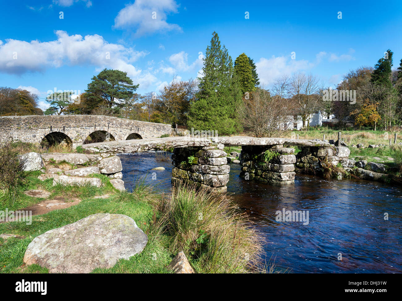An ancient clapper bridge and arched bridge crossing the East Dart ...