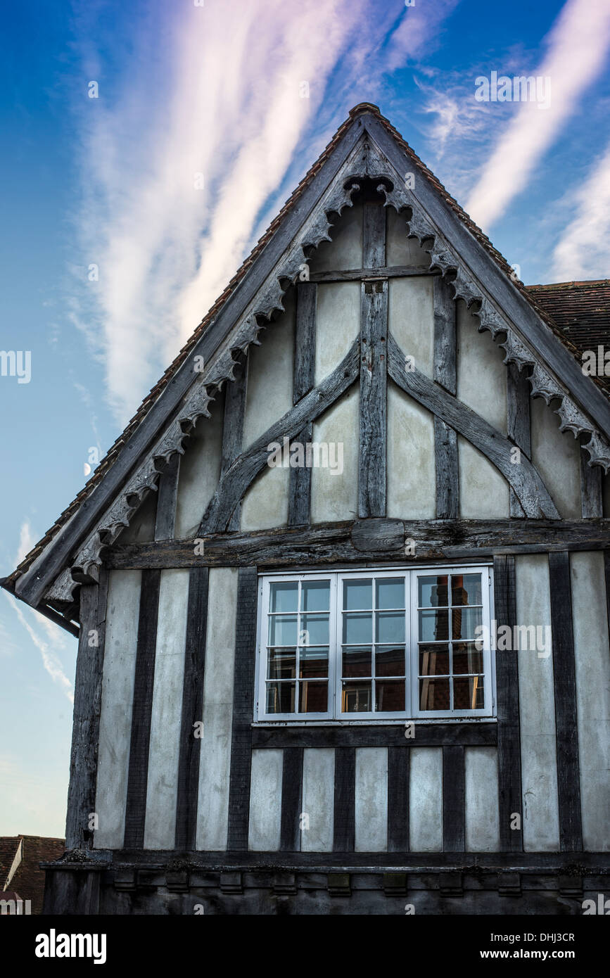 Tudor gable in small town in England, with one window, blue sky and ...
