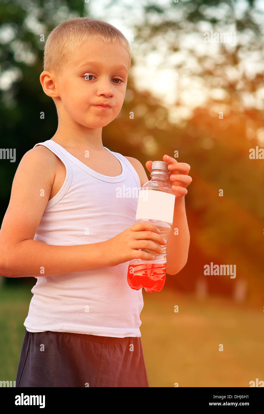 Boy Child caucasian drinking Juice Beverage plastic bottle hot weather ...