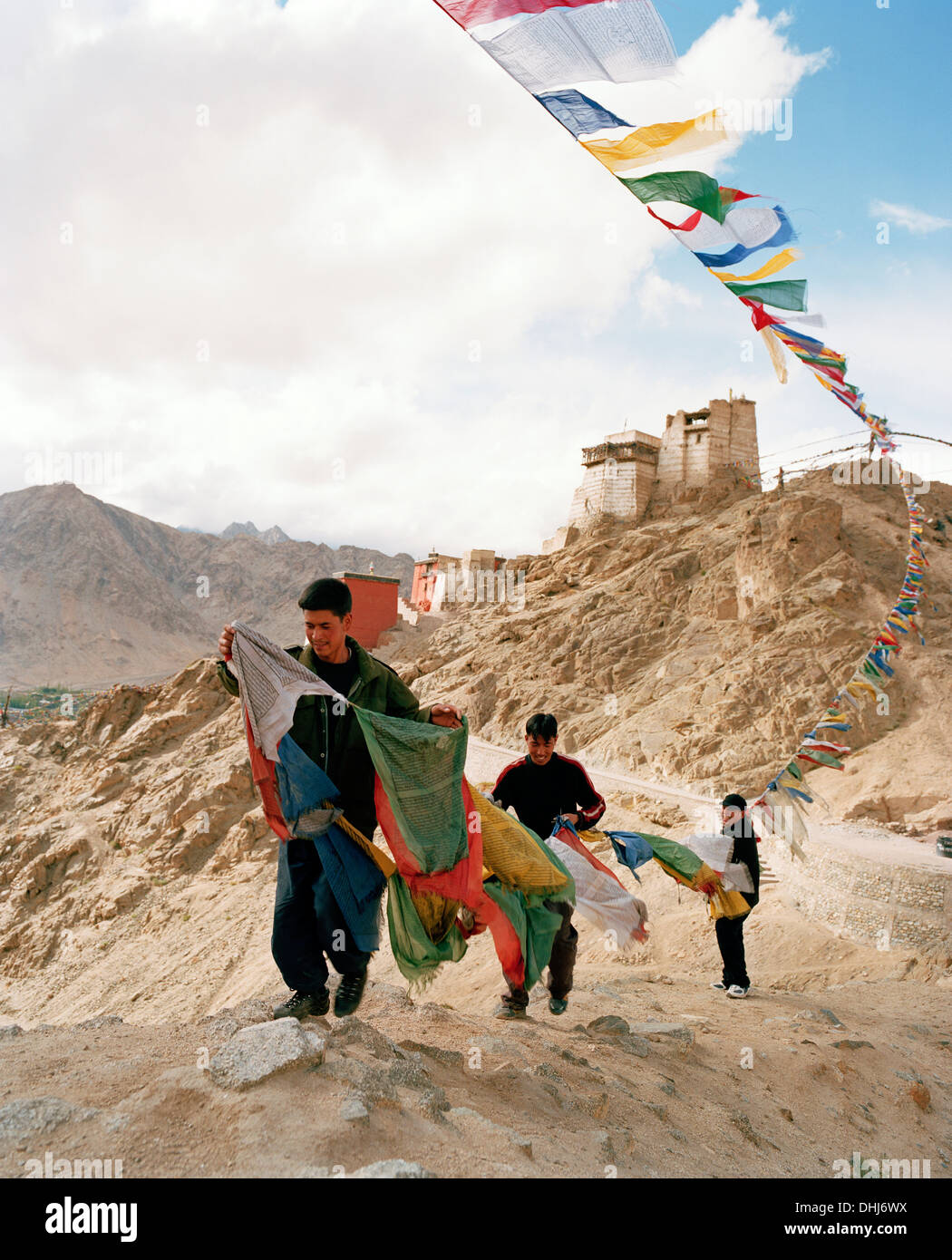 Men with buddhist prayer flags over capital Leh, Indus valley, Ladakh ...