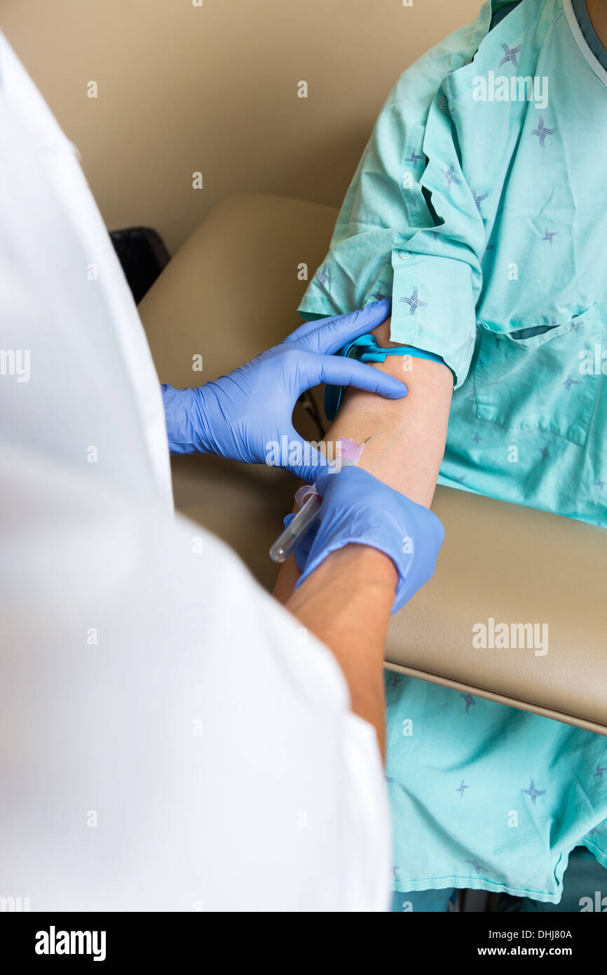 Male Doctor Drawing Blood From Patient's Arm Stock Photo - Alamy