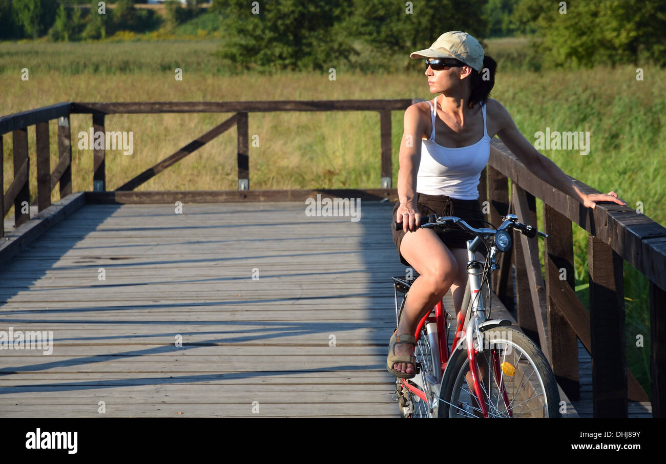 Girl riding bicycle in country side Stock Photo - Alamy