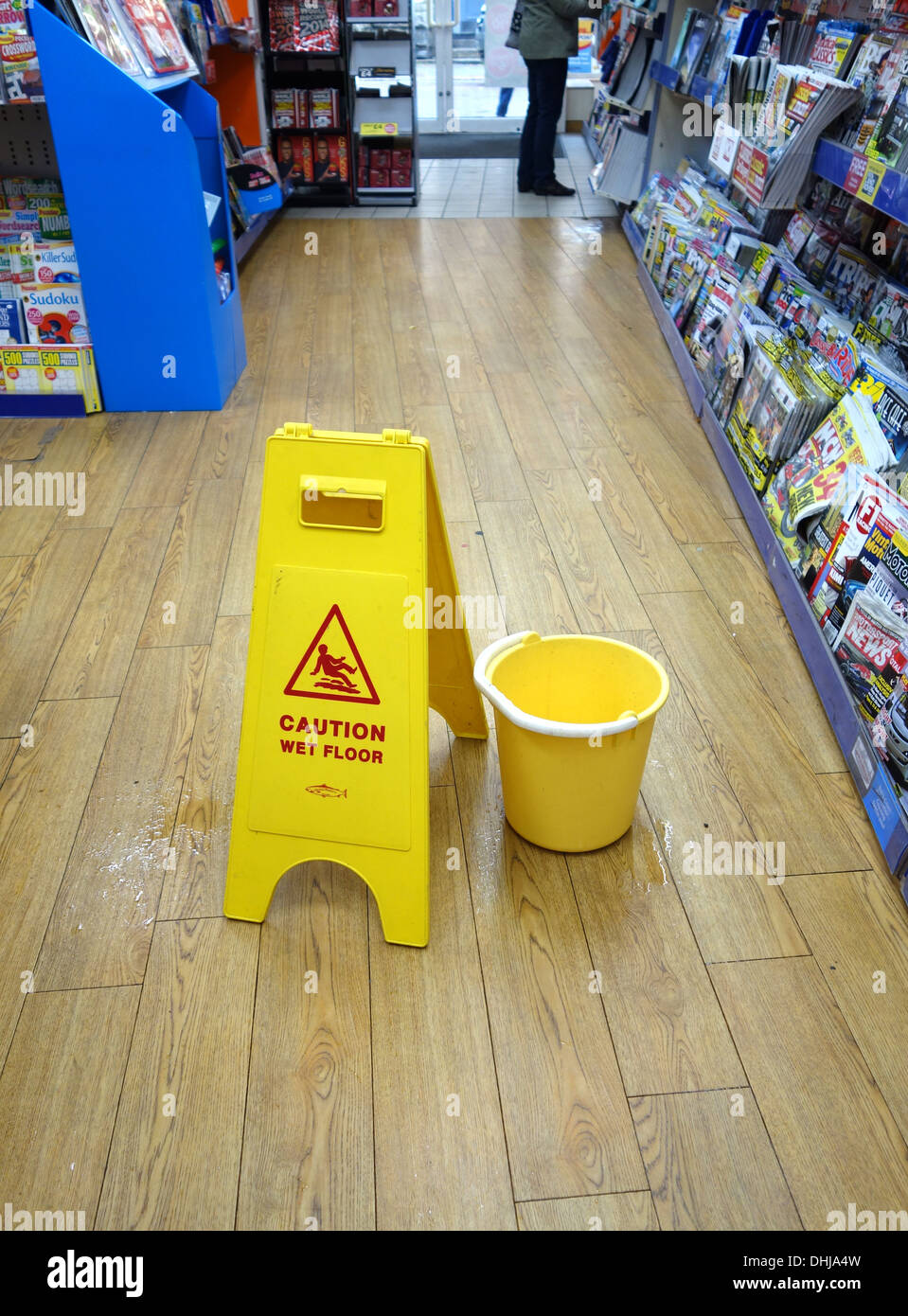A caution " wet floor " sign in a shop Stock Photo - Alamy