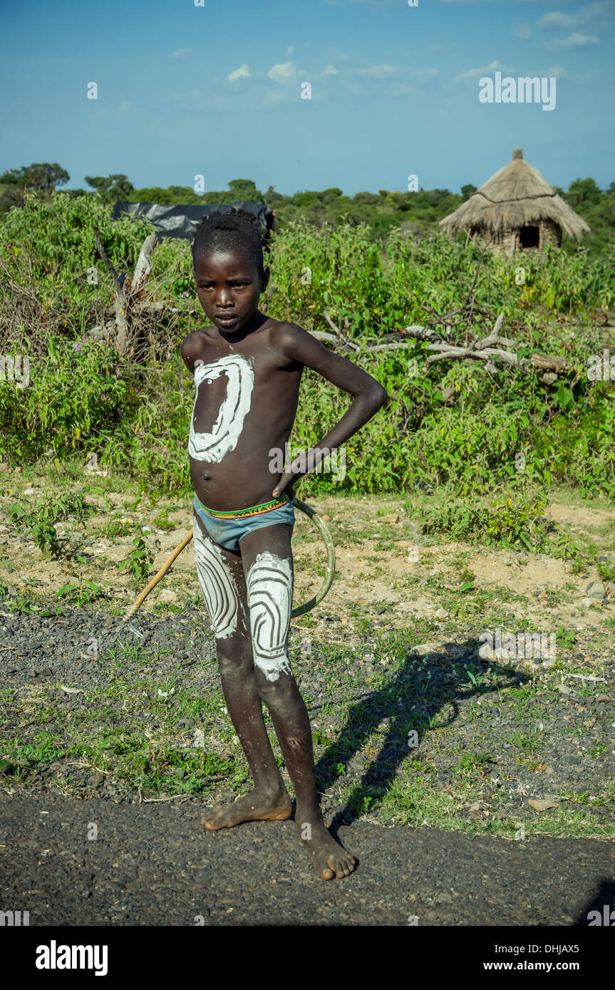 A member of the tribe poses to be taken a picture in Omo Valley ...