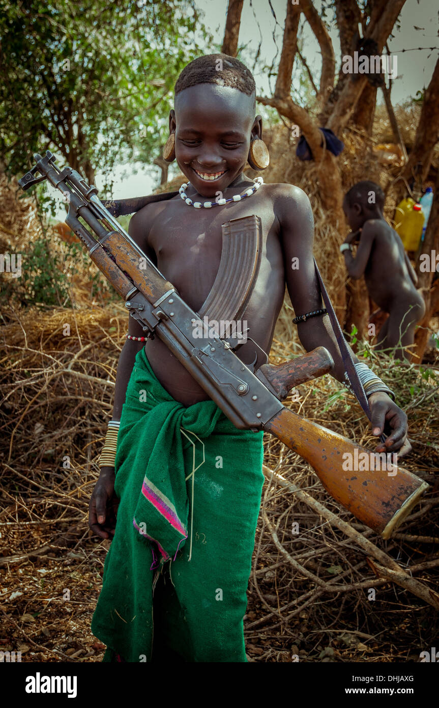 A member of the tribe poses to be taken a picture in Omo Valley ...