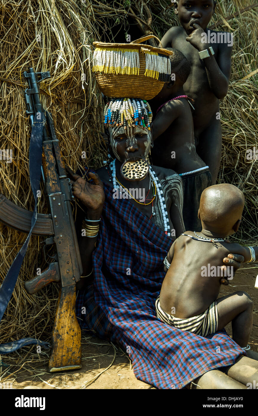 A member of the tribe poses to be taken a picture in Omo Valley ...