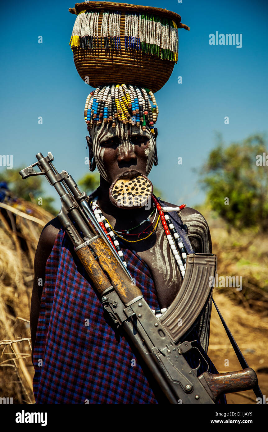 A member of the tribe poses to be taken a picture in Omo Valley ...
