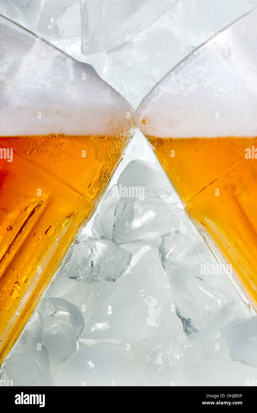 Glass of cold beer lying in the ice Stock Photo - Alamy