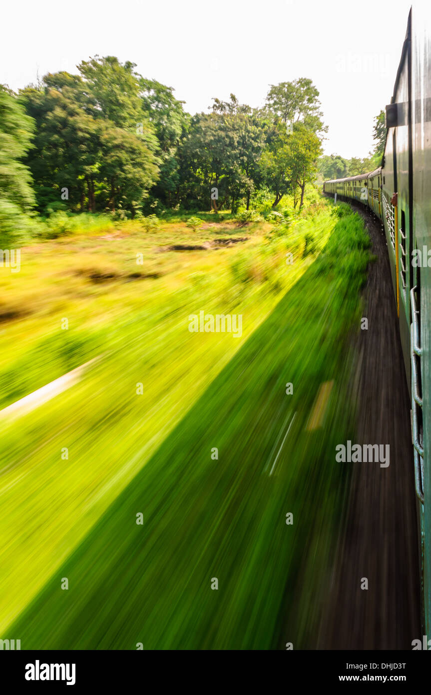View through window of a speeding Express train passing through forest ...