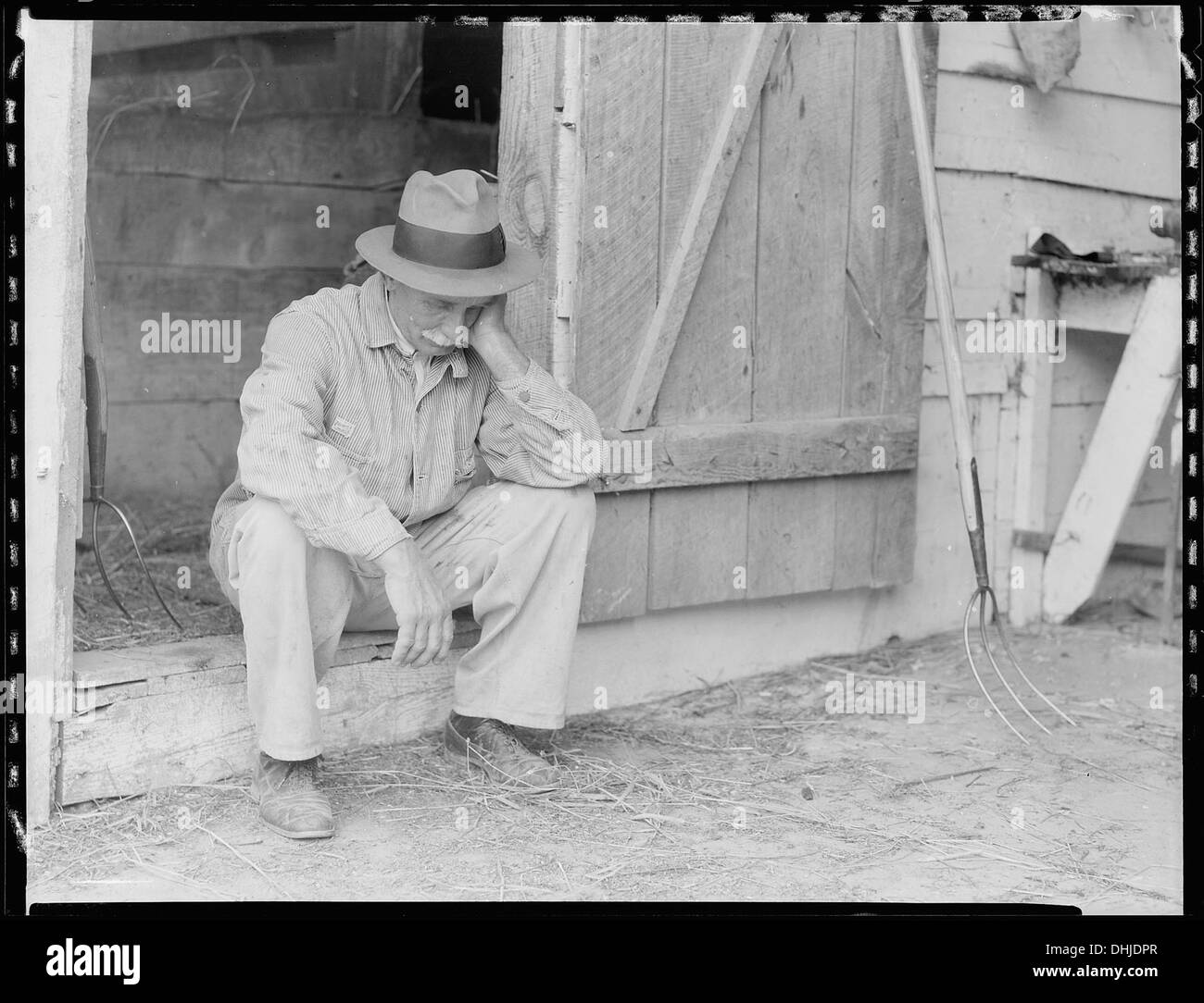 A farmer is shown in a moment of despair during the Great Depression of ...
