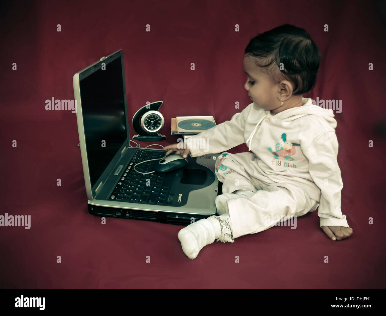Baby playing with laptop computer Stock Photo - Alamy
