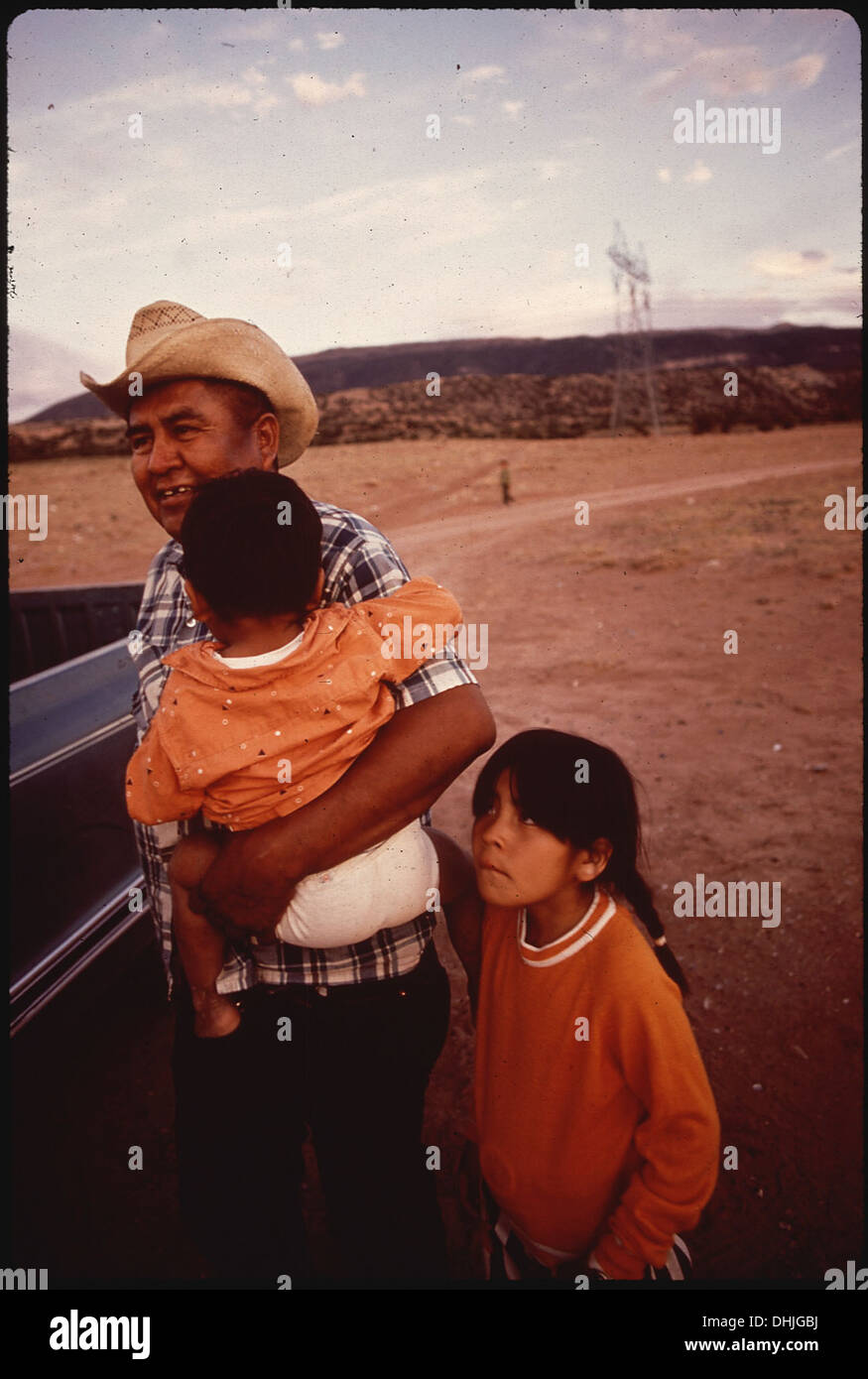 A Navajo father and his children are pictured, reflecting the family's ...