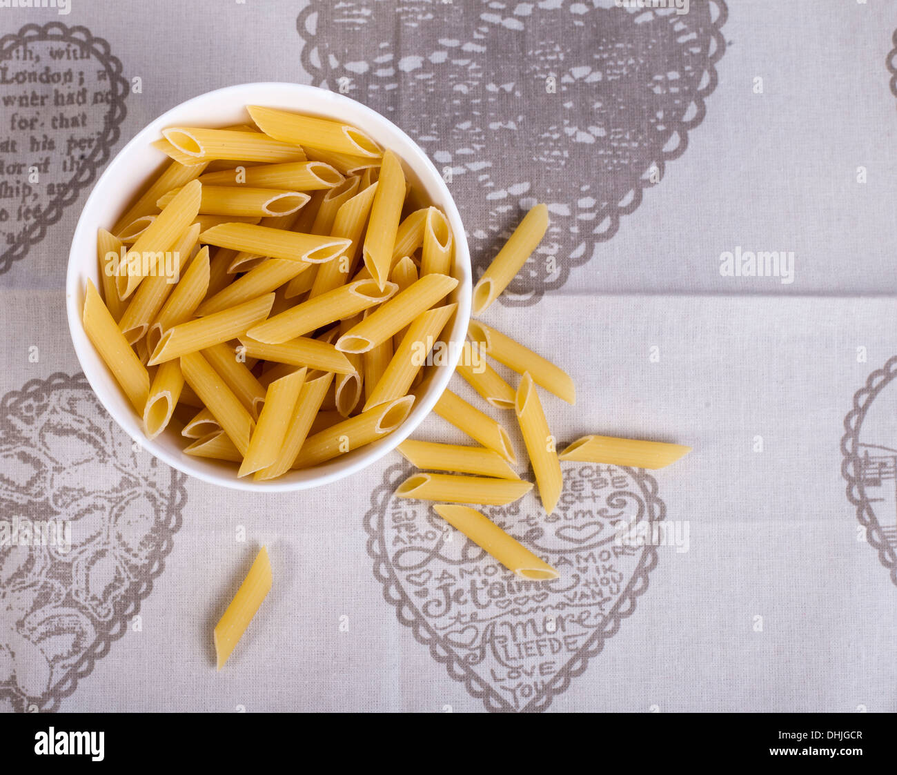 White bowl of dried penne pasta Stock Photo - Alamy