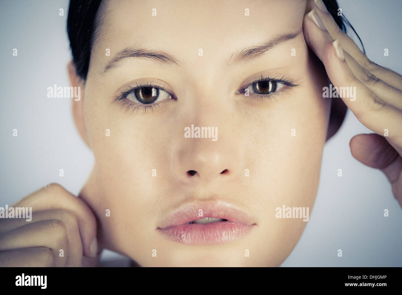 A young woman stretching the skin on her face Stock Photo - Alamy