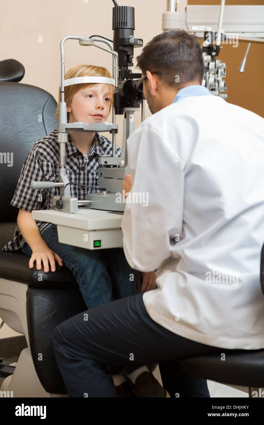 Optician Examining Boy's Eyes With Slit Lamp Stock Photo - Alamy